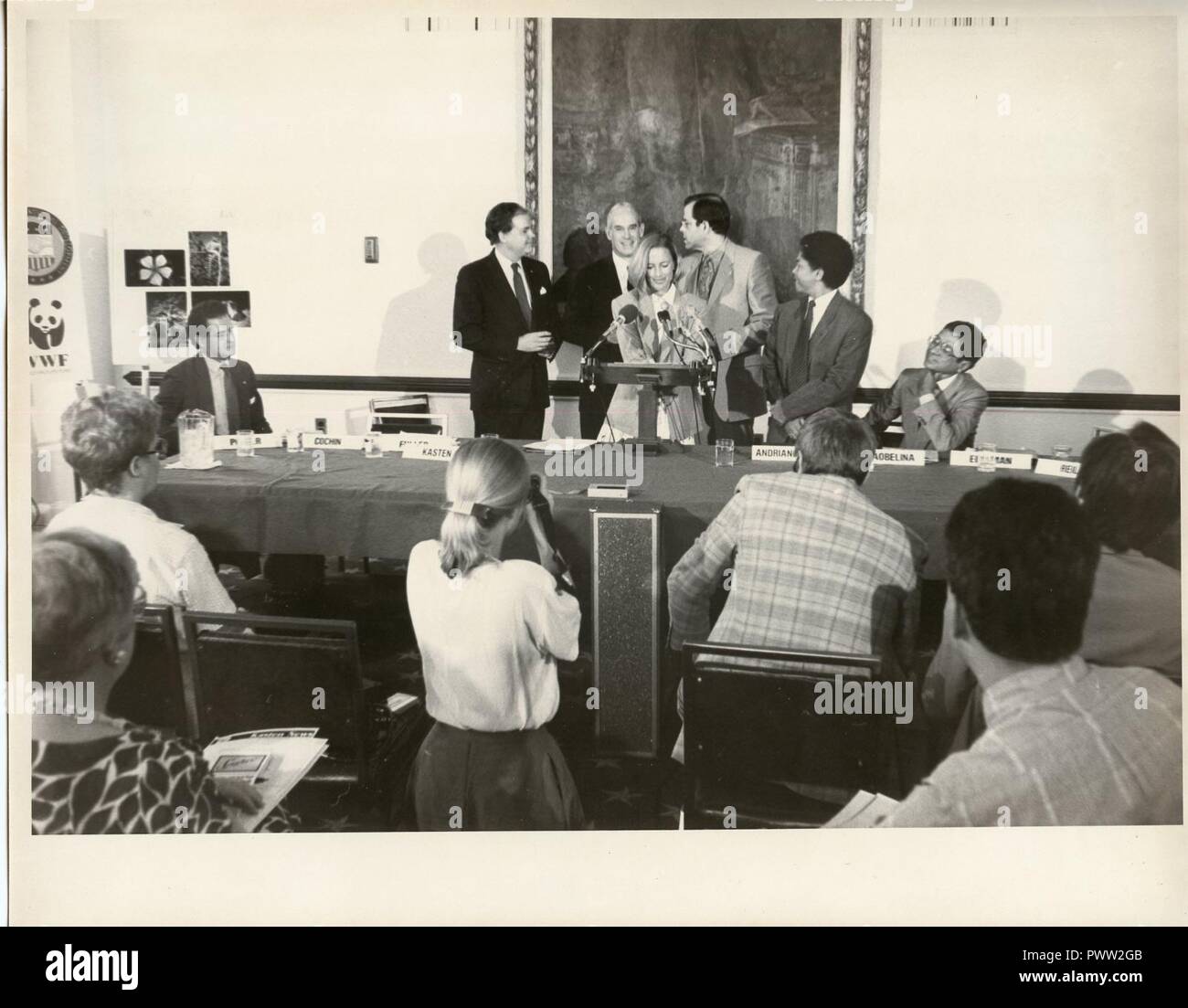 THERE ARE A GROUP OF PEOPLE STANDING AT THE PODIUM WITH OTHER MEN AND ...