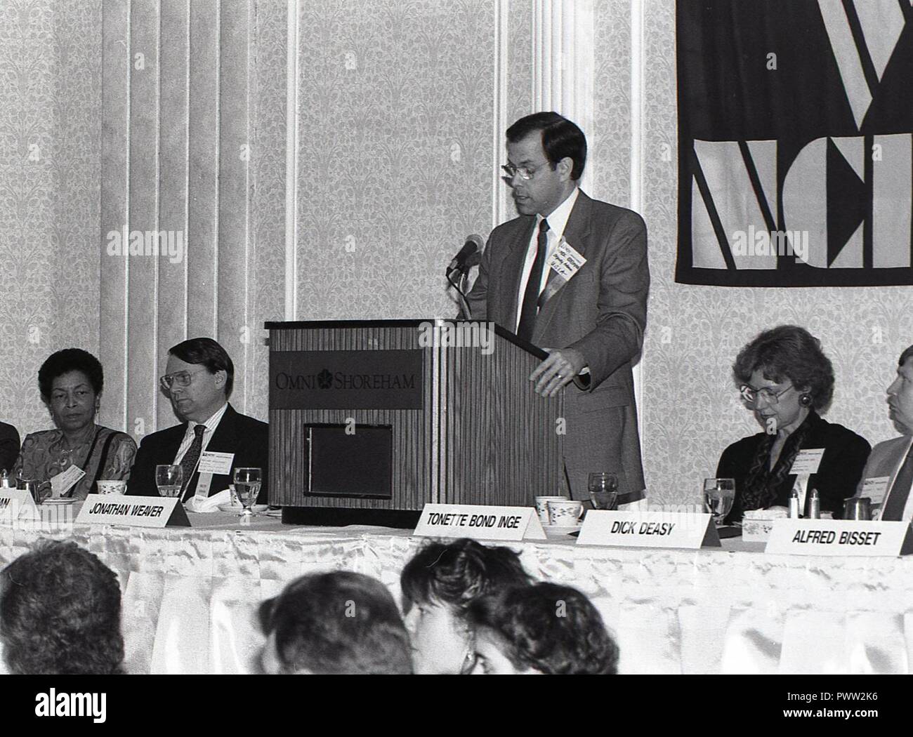 YOU HAVE A MAN AT THE PODIUM GIVING HIS SPEECH TO A GROUP OF MEN AND ...