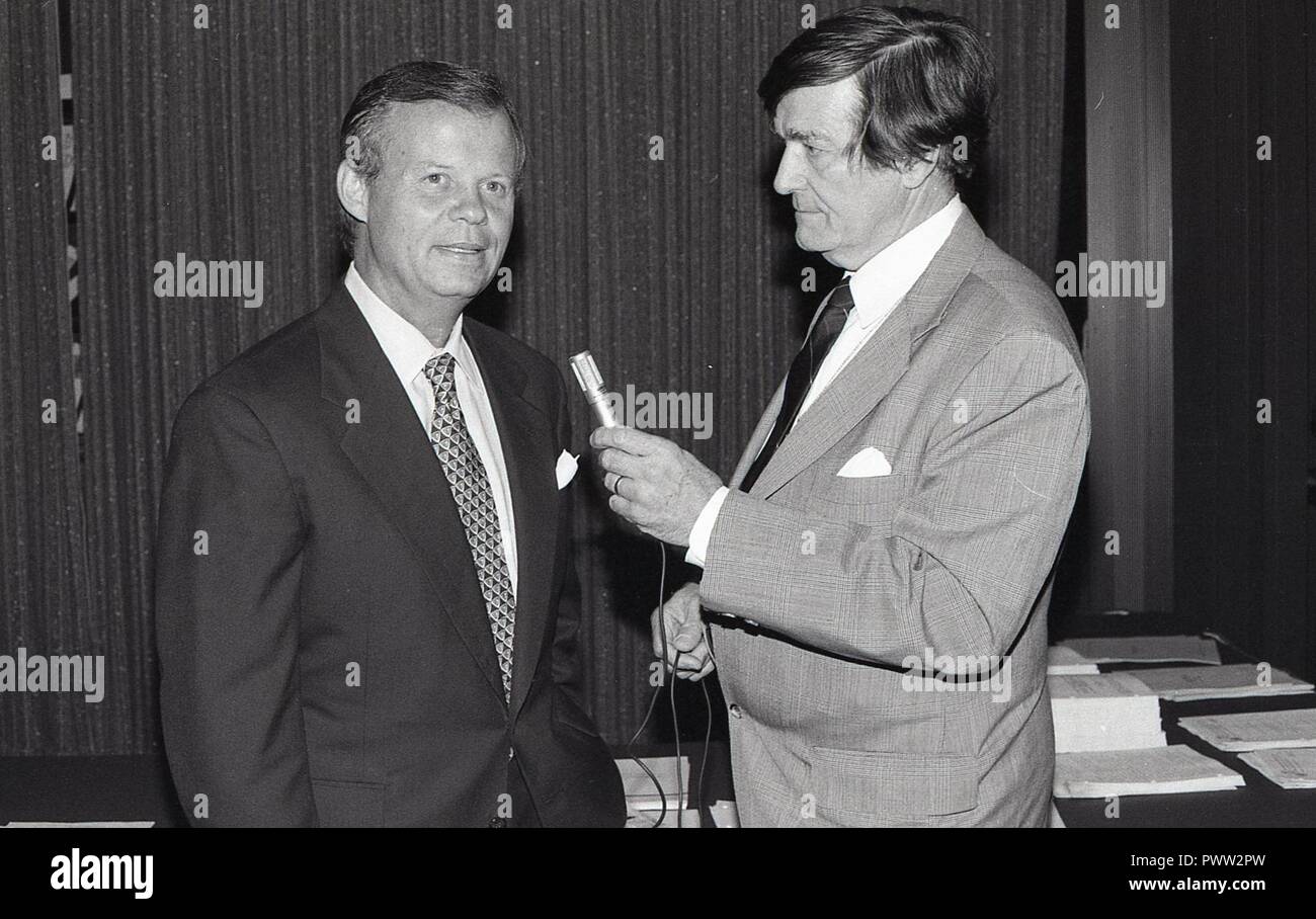 A REPORTER IS INTERVIEWING A MAN Stock Photo - Alamy