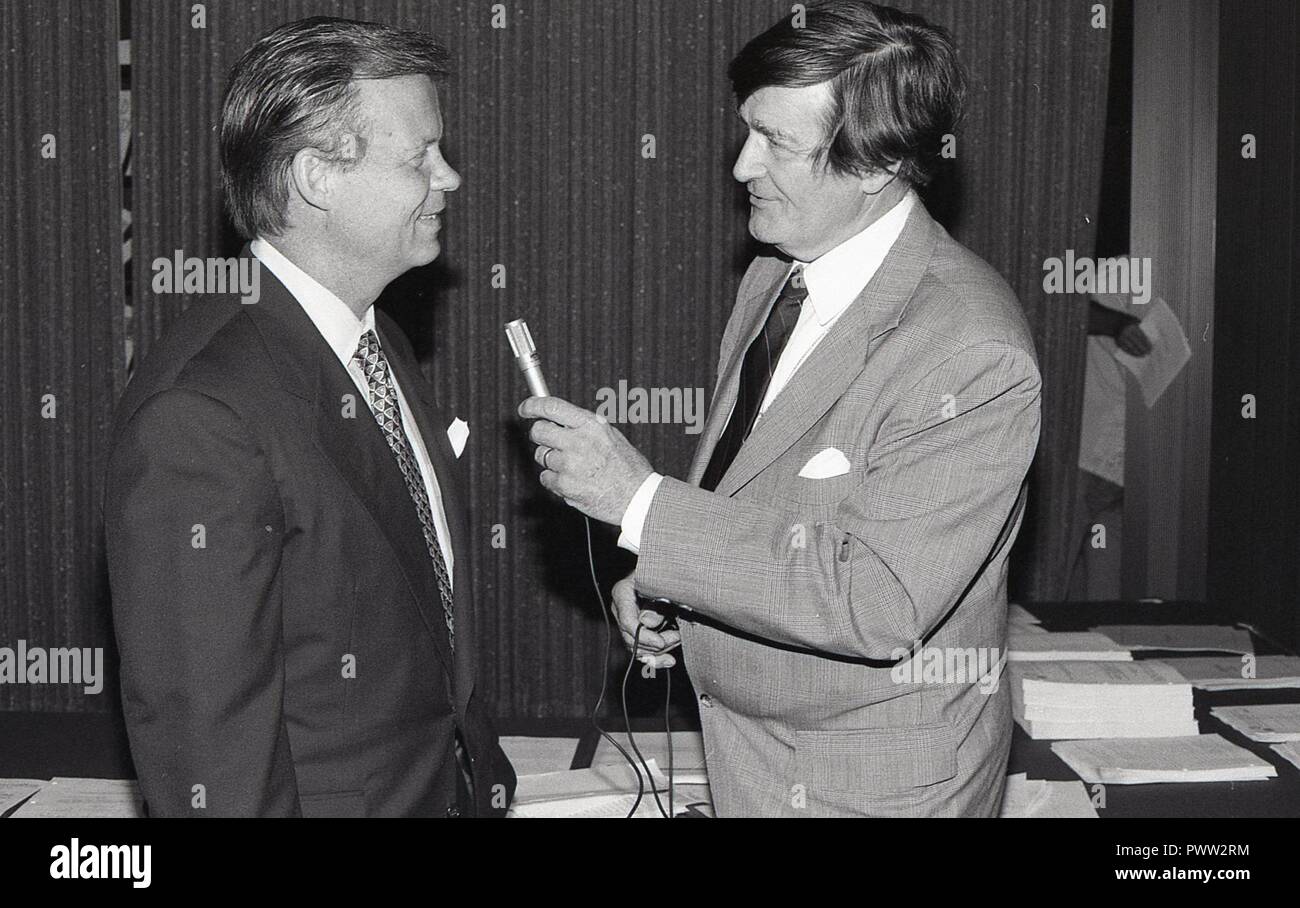 A REPORTER IS INTERVIEWING A MAN Stock Photo - Alamy