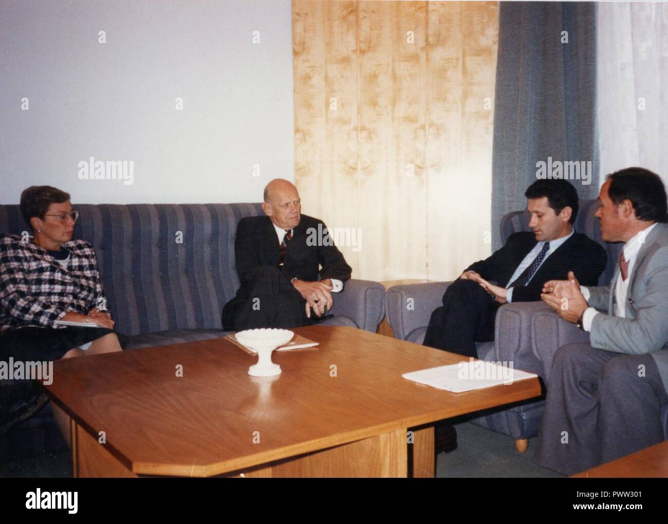 THREE MEN AND A WOMAN ARE HAVING A CONVERSATION Stock Photo - Alamy