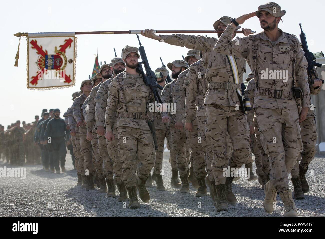 The Spanish army render a salute with hand and guideon as they march ...