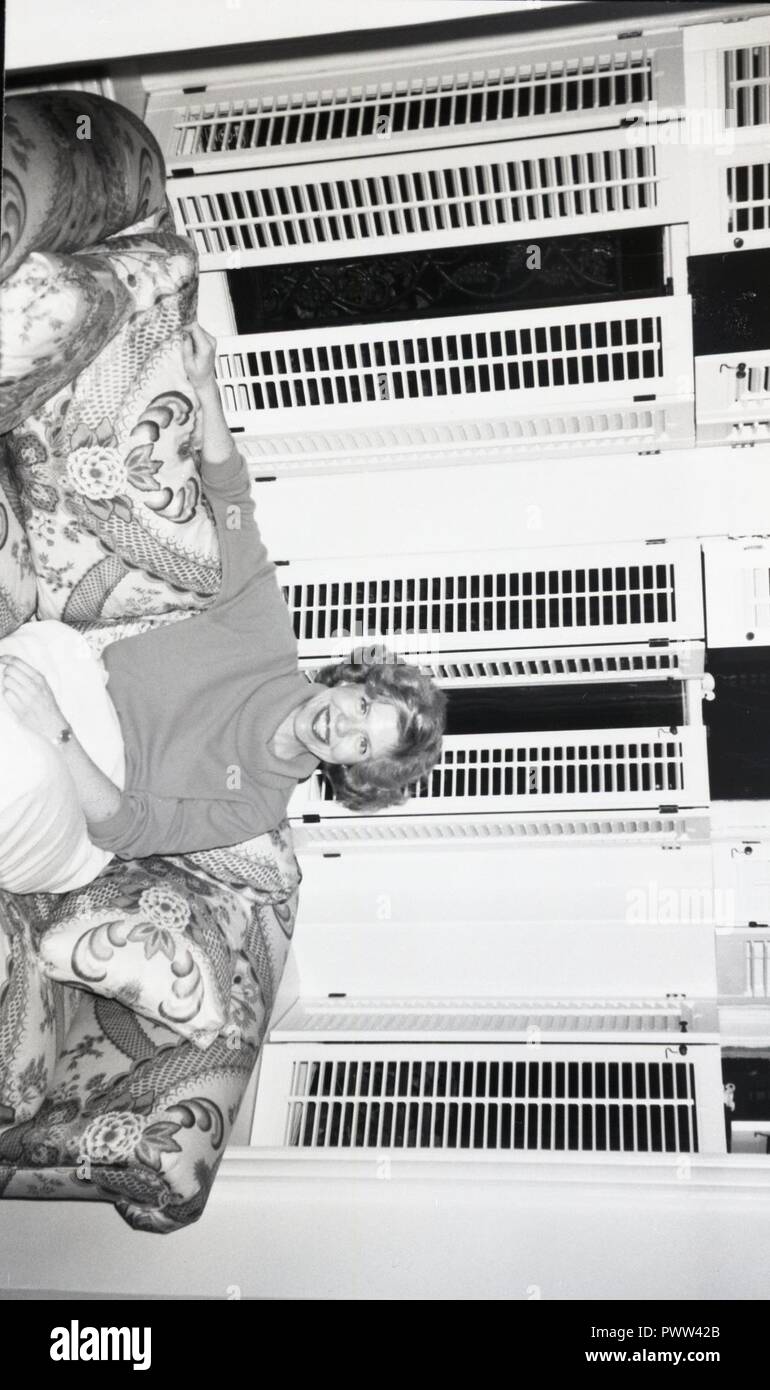 BARBARA UPTON IS SMILING SITTING ON HER SOFA Stock Photo - Alamy