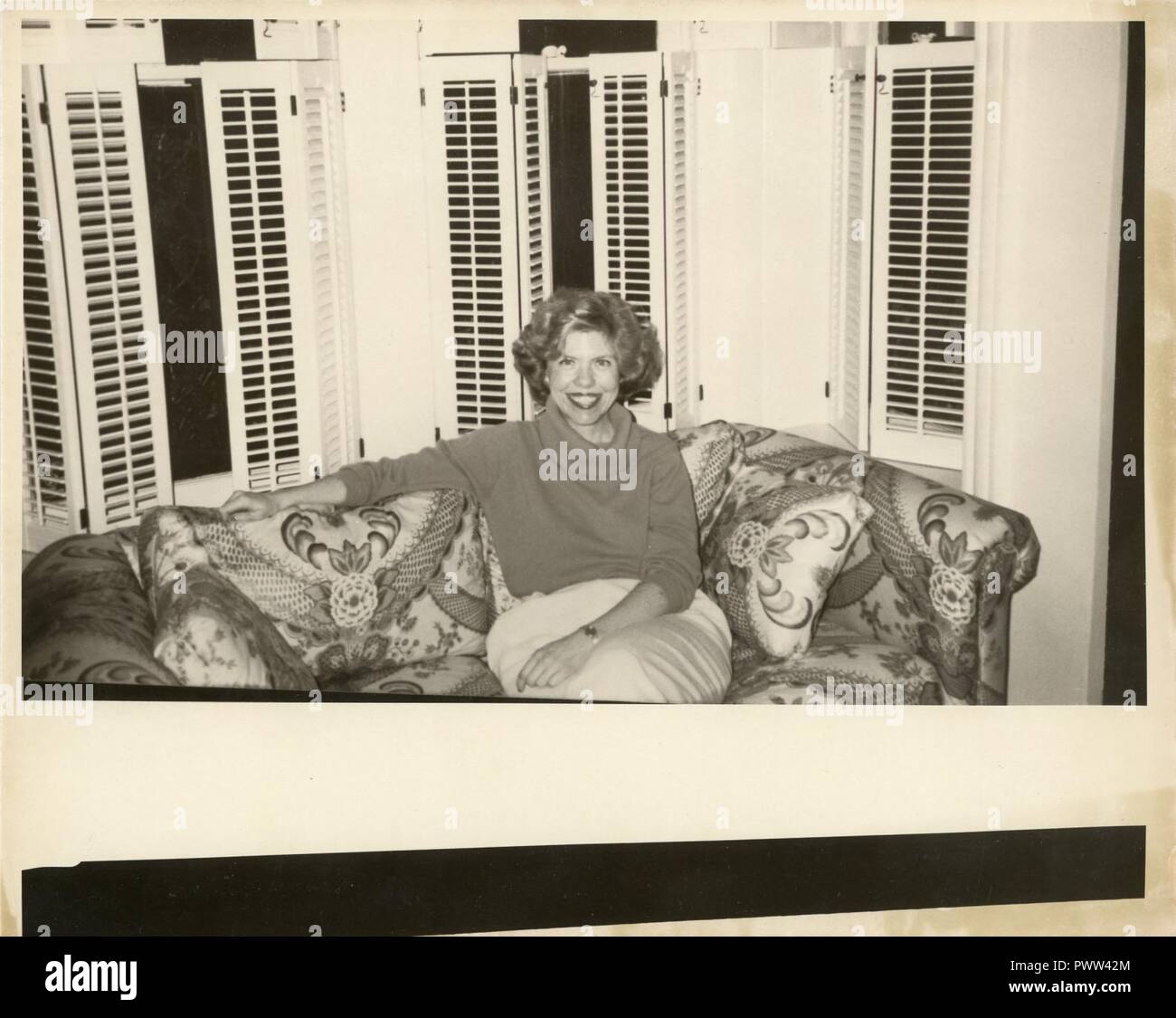 BARBARA UPTON IS SMILING SITTING ON HER SOFA Stock Photo - Alamy