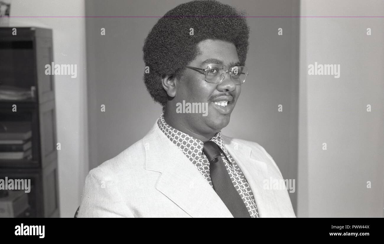 THIS IS A PHOTO OF BOB WARD SMILING WITH HIS SUIT AN TIE AND GLASSES AT ...