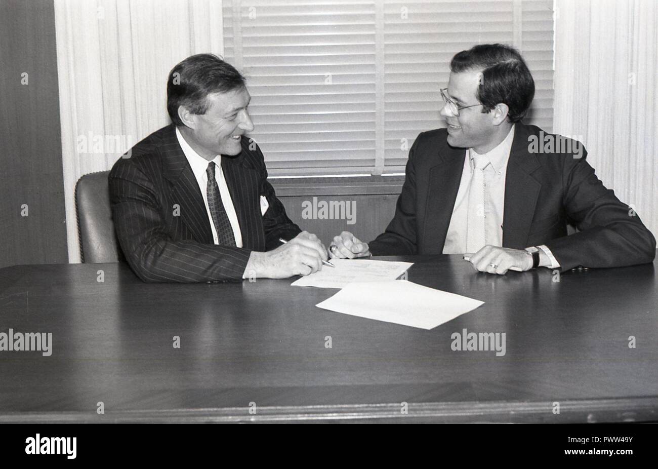 DWIGHT WILSON HAVING A CONVERSATION WITH ANOTHER MAN GOING OVER SOME ...