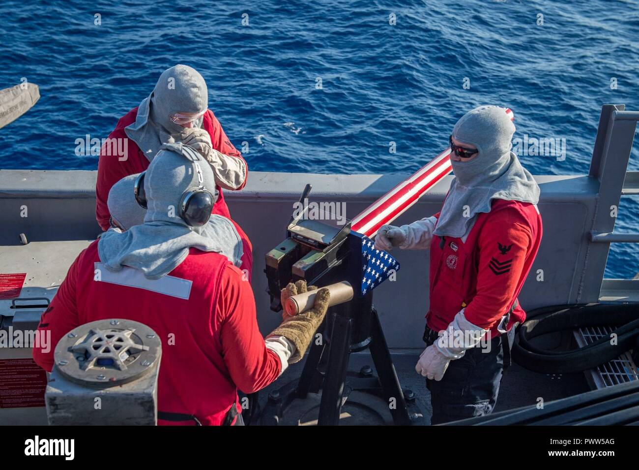 PACIFIC OCEAN (June 26, 2017) - A Sailor loads a shell into a 40mm ...