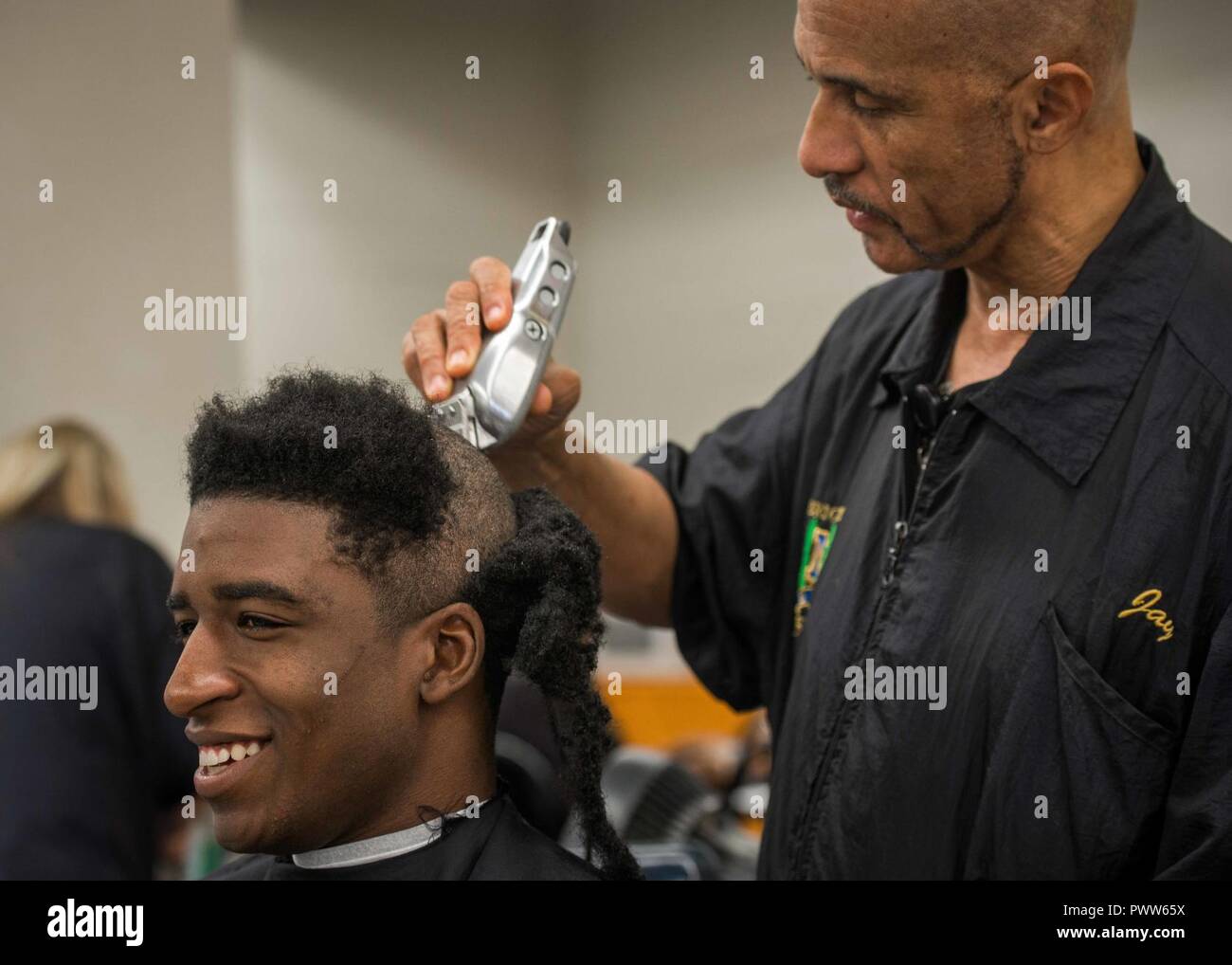 ANNAPOLIS, Md. (June 29, 2017) Jay Dunn shaves the head of Myles Fells ...