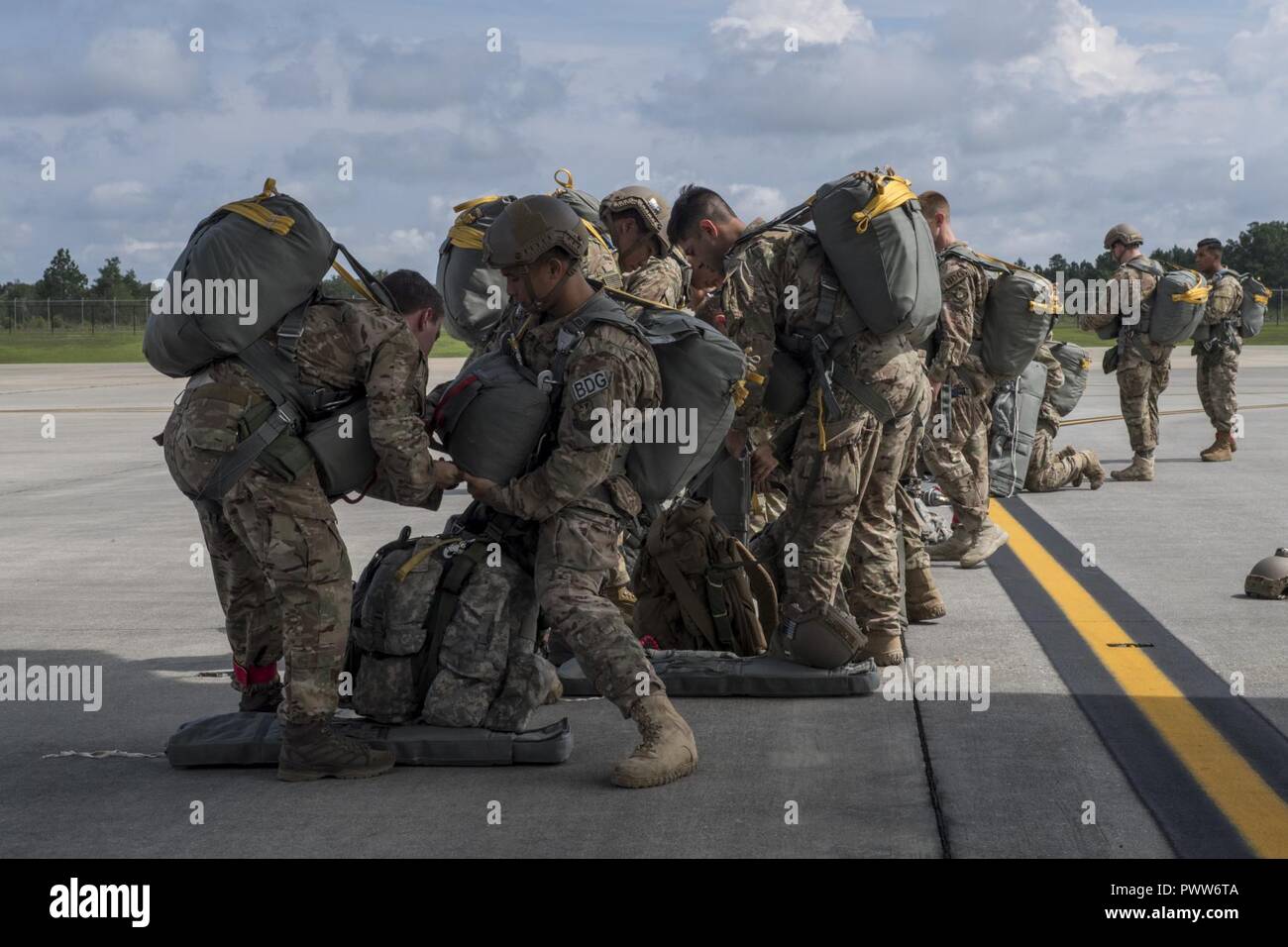 Members of the 820th Base Defense Group wait to board an HC-130J Combat ...
