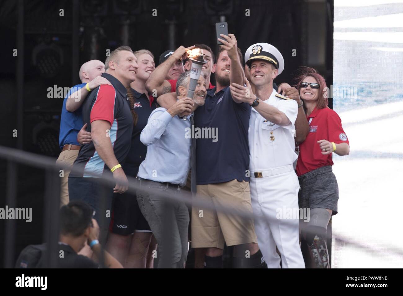 Jon Stewart and Admiral John Richardson, CNO, pose for a "selfie"with ...