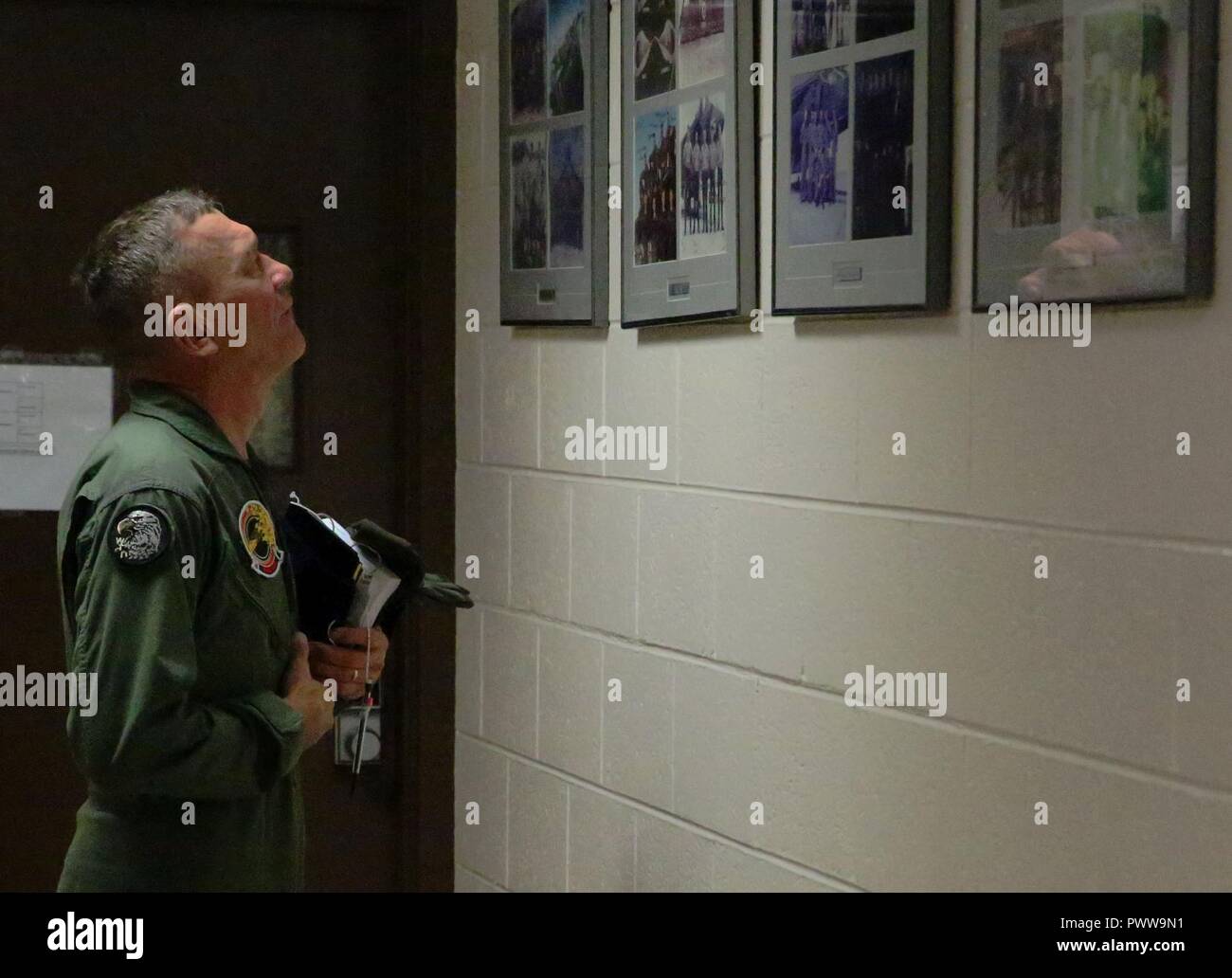 Lt. Gen. Jon Davis, looks at the photos of previous pilot instructors ...
