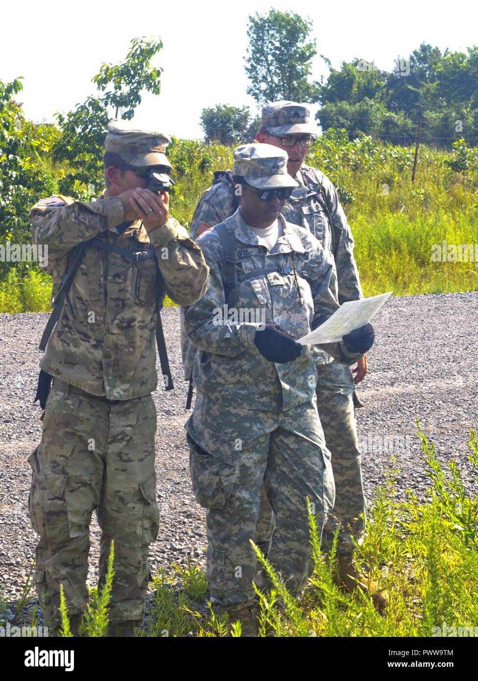 Oklahoma Army National Guardsmen use a map and compass to plot the ...
