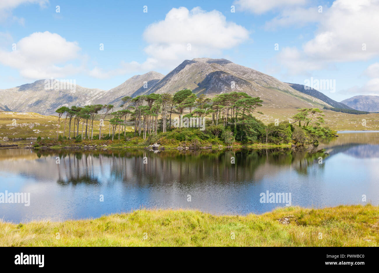 A mountainous landscape reflected in Derryclare Lough, in the Inagh ...