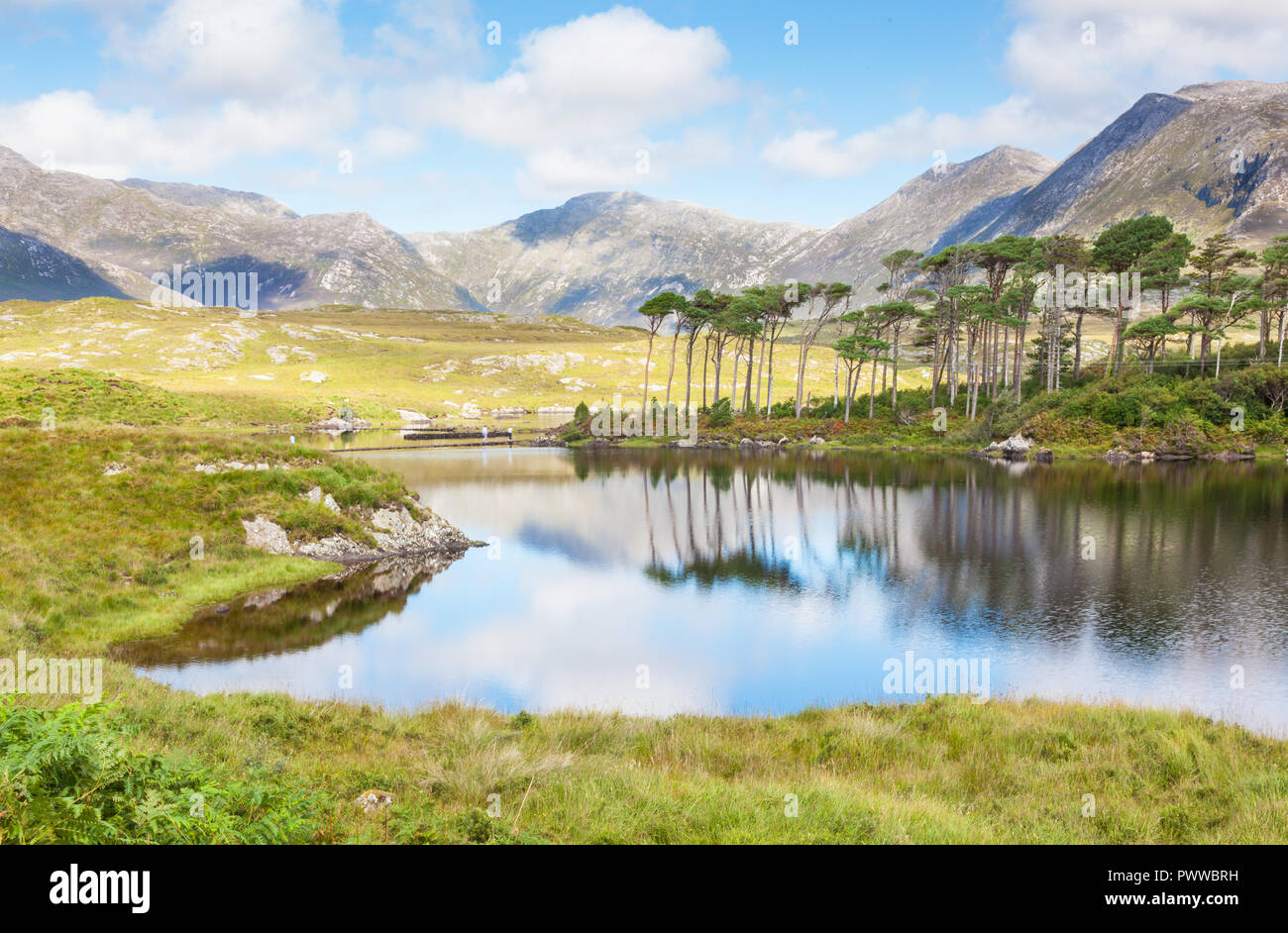 A mountainous landscape reflected in Derryclare Lough, in the Inagh ...