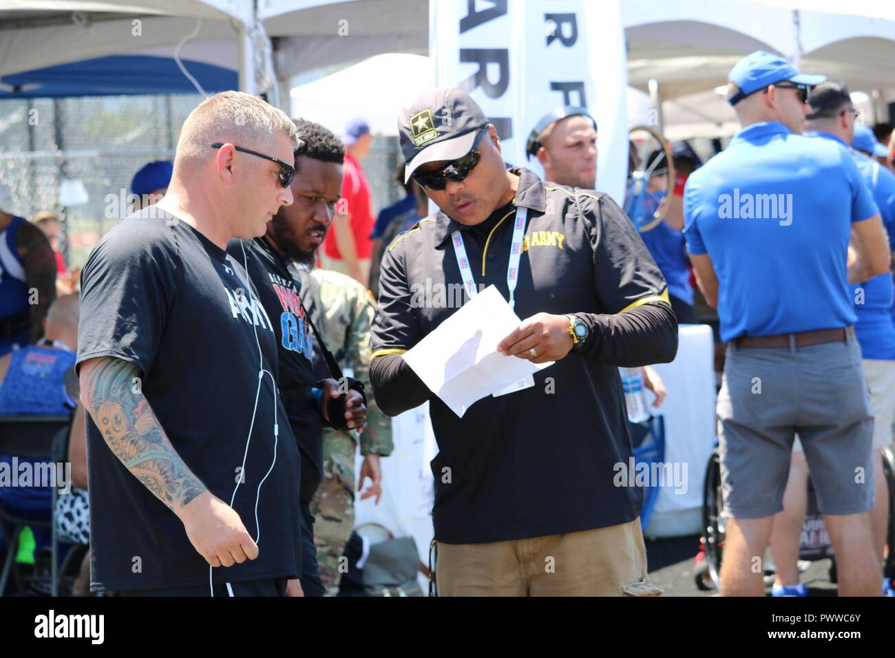 Team Army track coach Rodney Carson goes over the lineup two of his ...