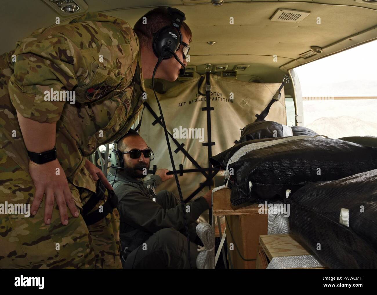 An Afghan Air Force C-208 pilot, prepares to deliver supplies, over ...