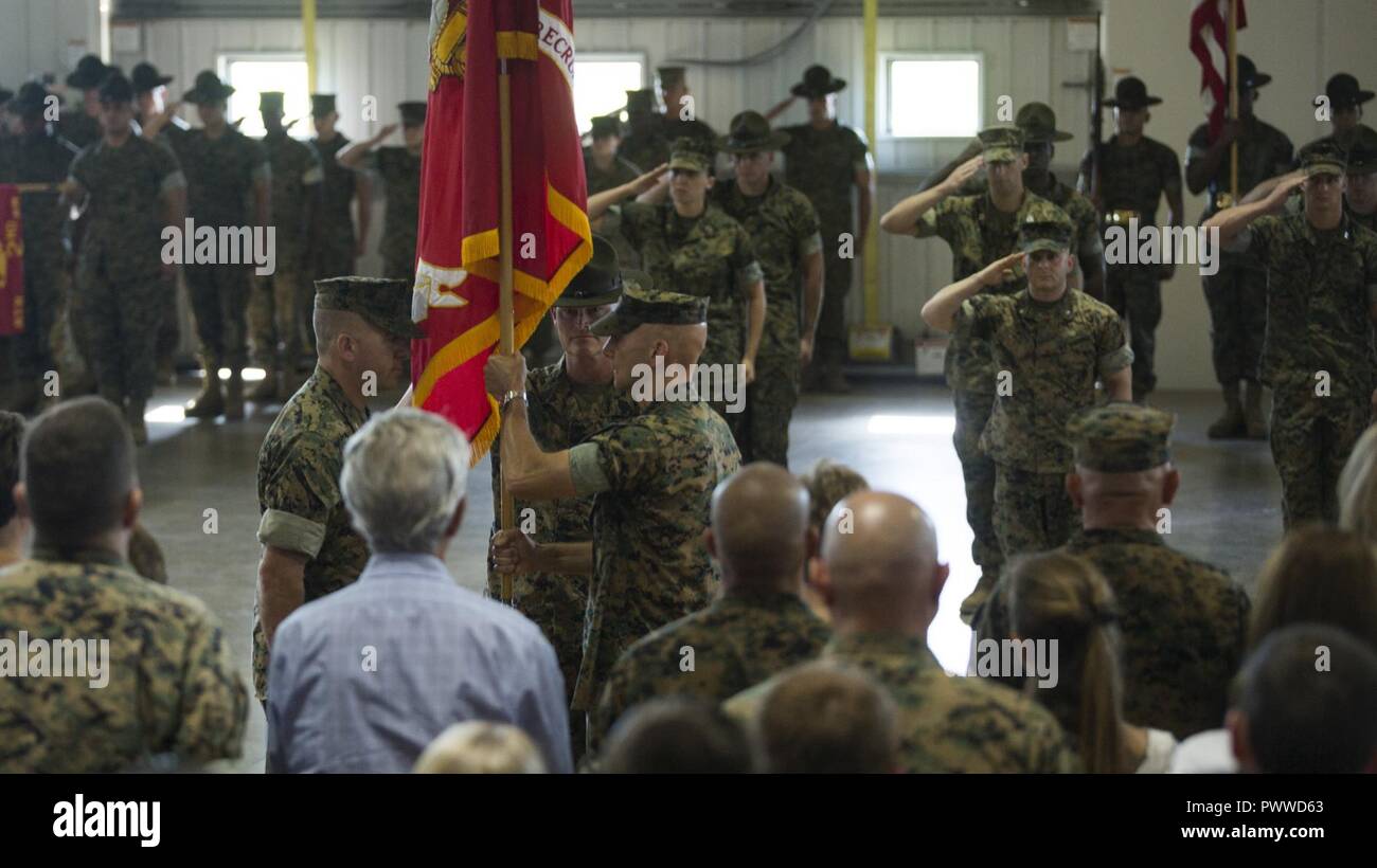 U.S. Marine Corps Col. Matthew St. Clair hands the regimental colors to ...