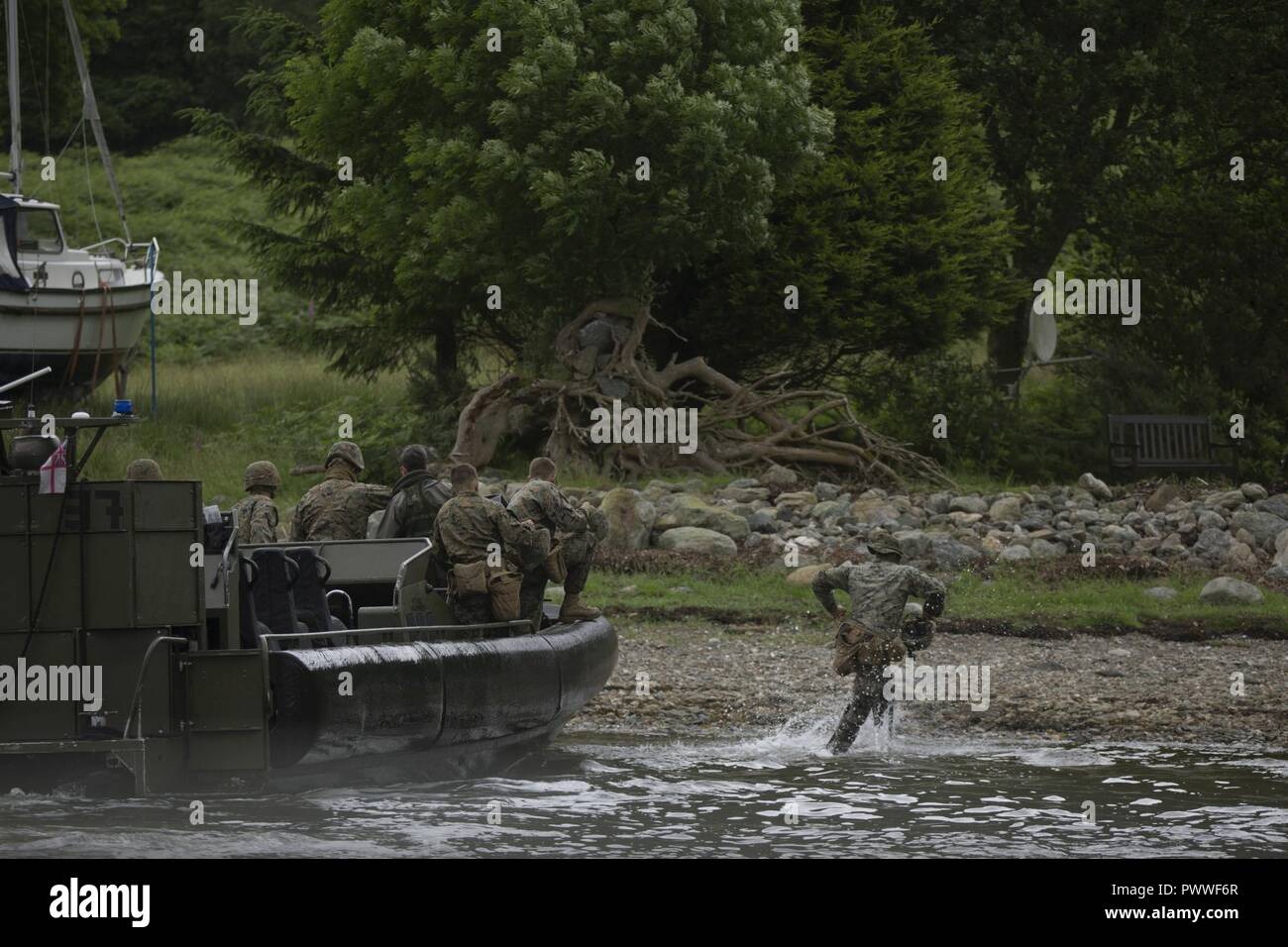 U.S. Marines disembark a British offshore riding craft and head to ...