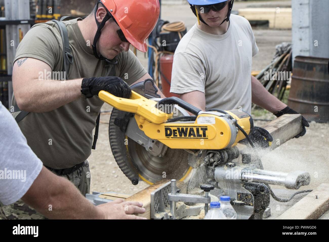 A soldier cuts a support that will be used in a shoring system at Volk ...