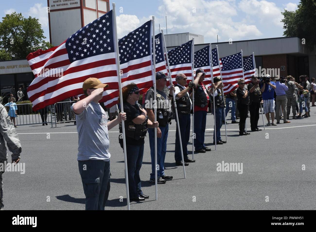 Members of the Patriot Guard Riders stand with the American Flags and ...