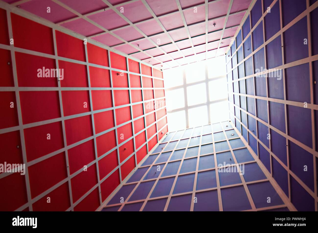 Abstract perspective of vertical lobby ceiling with skylight and strong ...