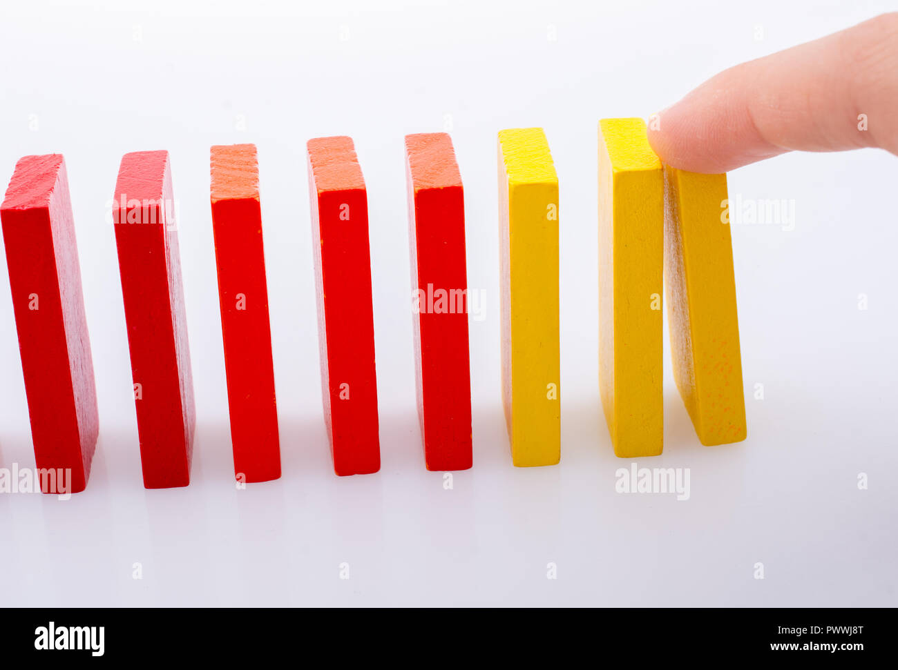 Hand holding color dominoes on a white background Stock Photo - Alamy