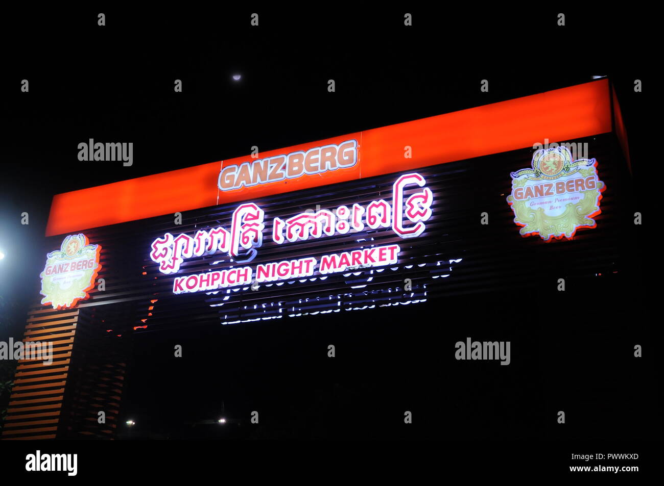 Illuminated bilingual "Koh Pich Night Market" sign w/ Ganzberg Beer ad ...