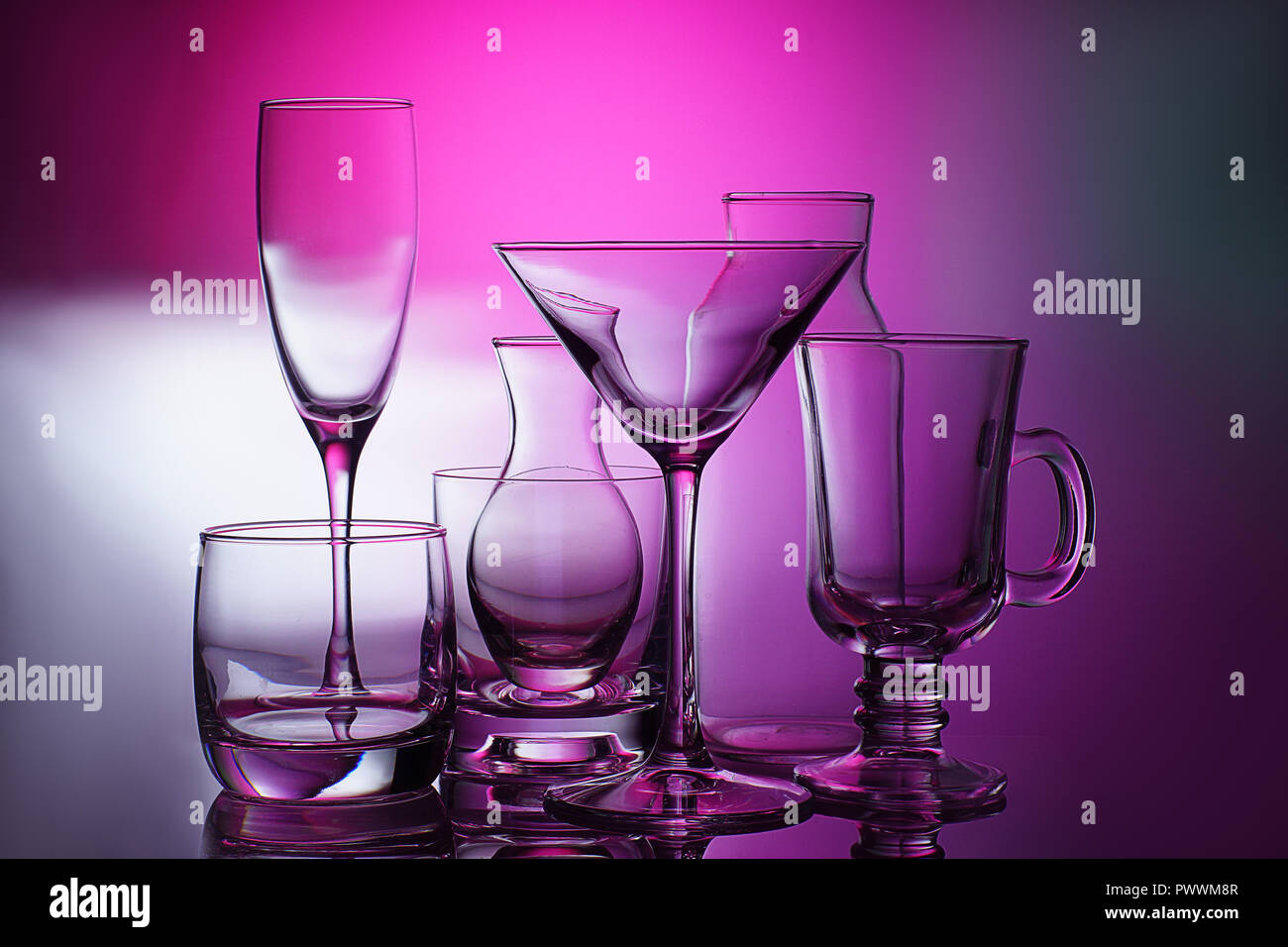 Glass, transparent, different glassware stand on a bright background ...