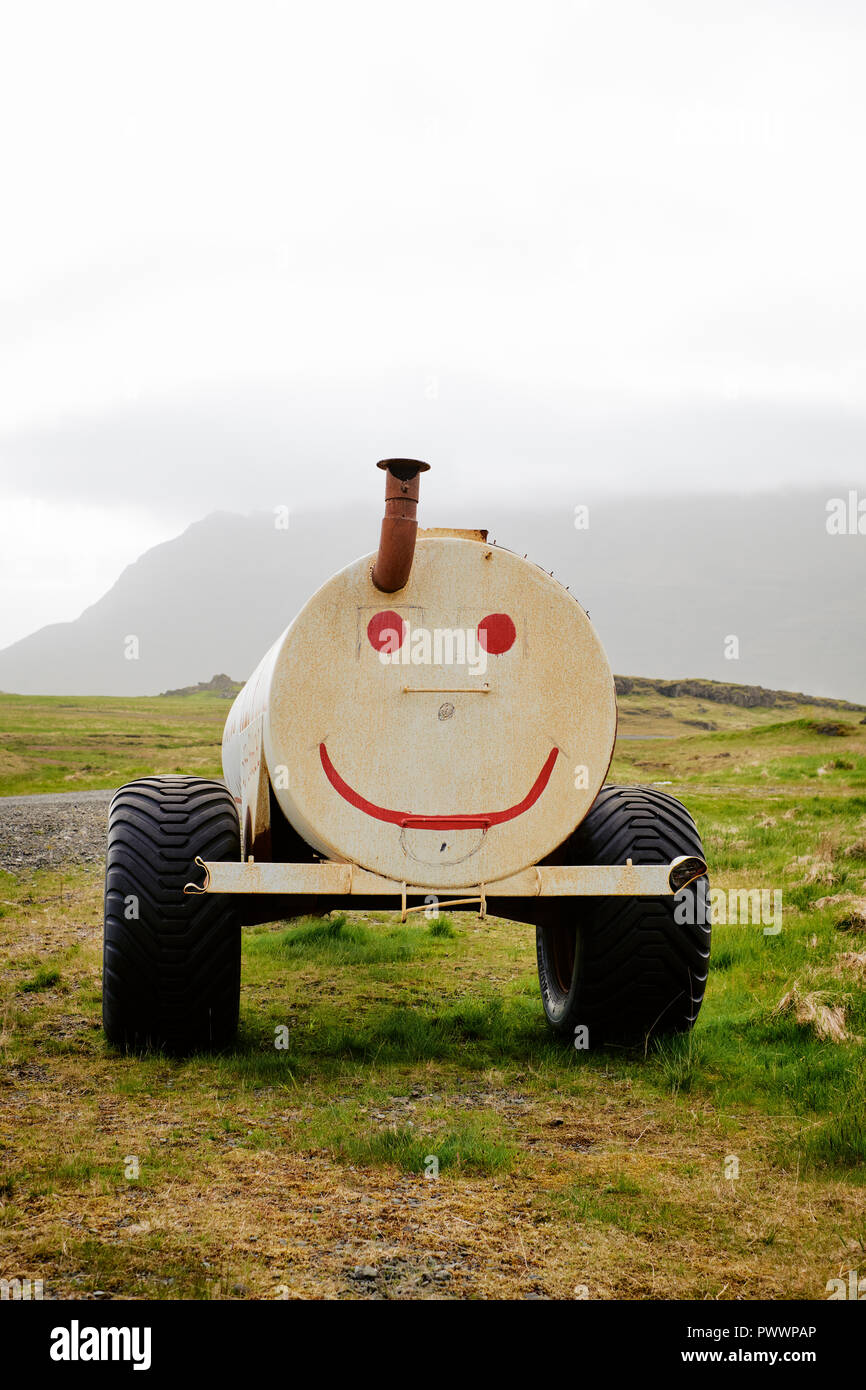 A smiley face painted on an farm trailer.smiley Stock Photo - Alamy