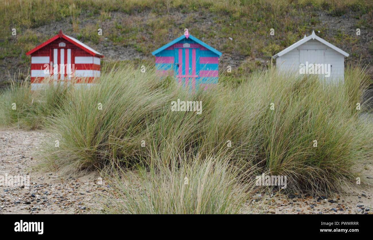 three colourful beach huts Stock Photo - Alamy