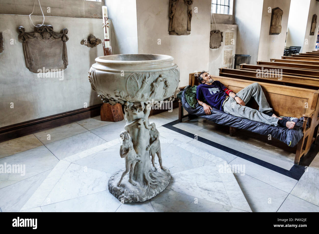 Person sleeping in church hi-res stock photography and images - Alamy