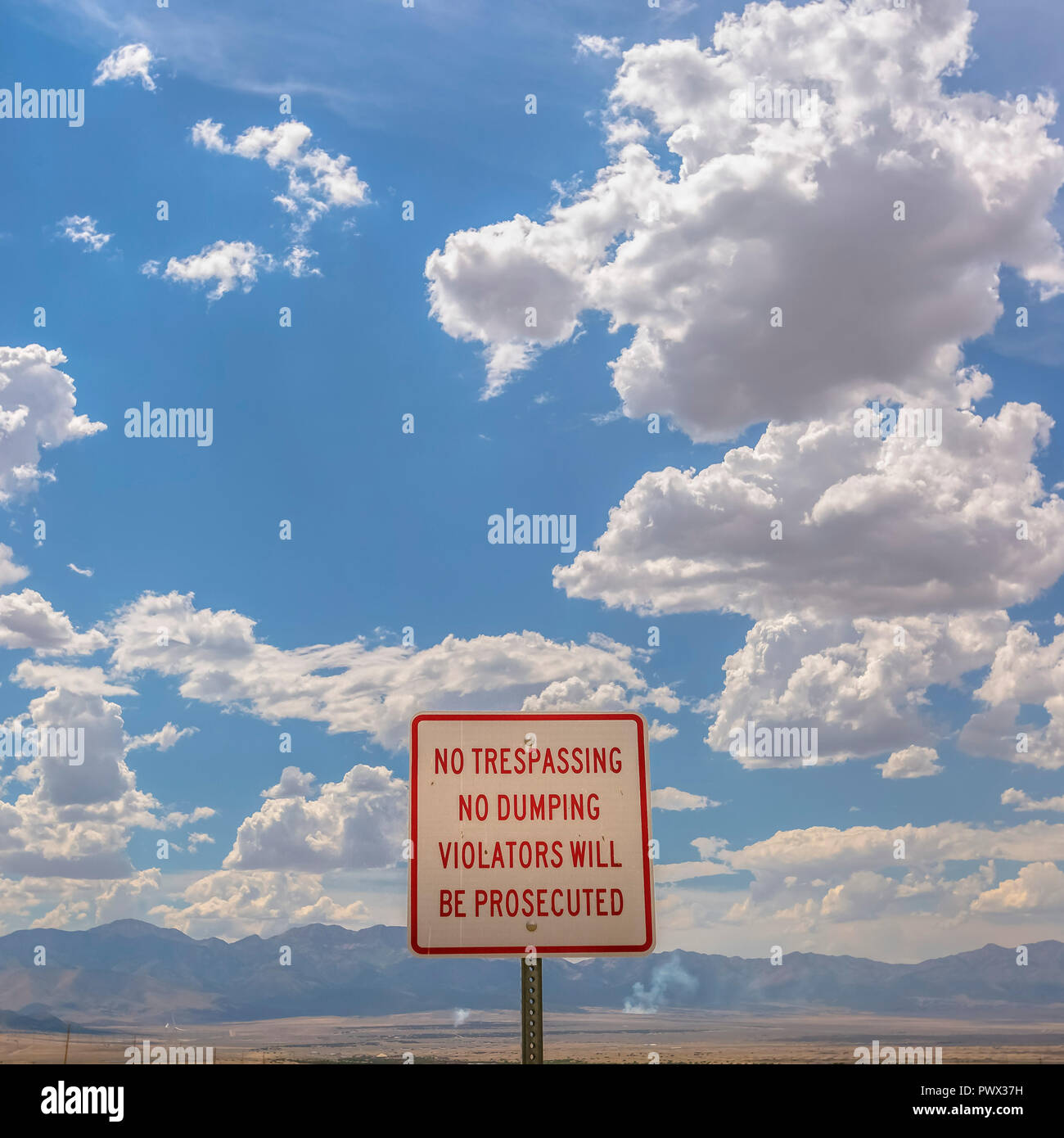 No trespassing sign overlooking mountain and sky Stock Photo - Alamy