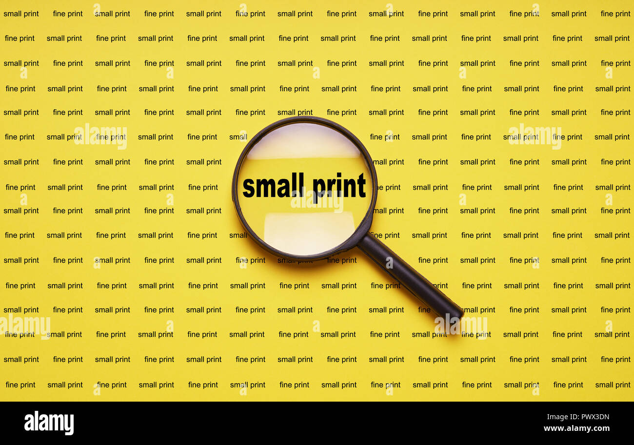 small print enlarged with magnifying glass magnifier loupe, business ...