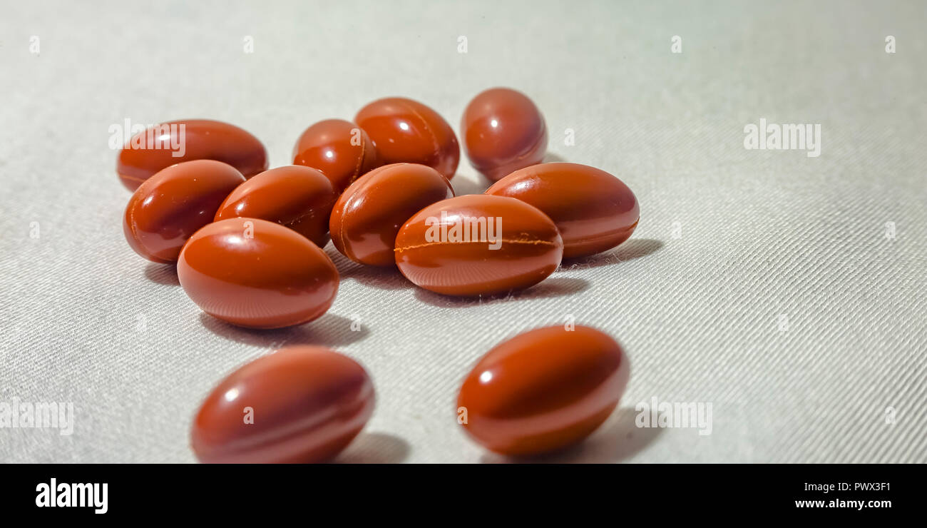 Oval shaped chocolates against a white background Stock Photo - Alamy