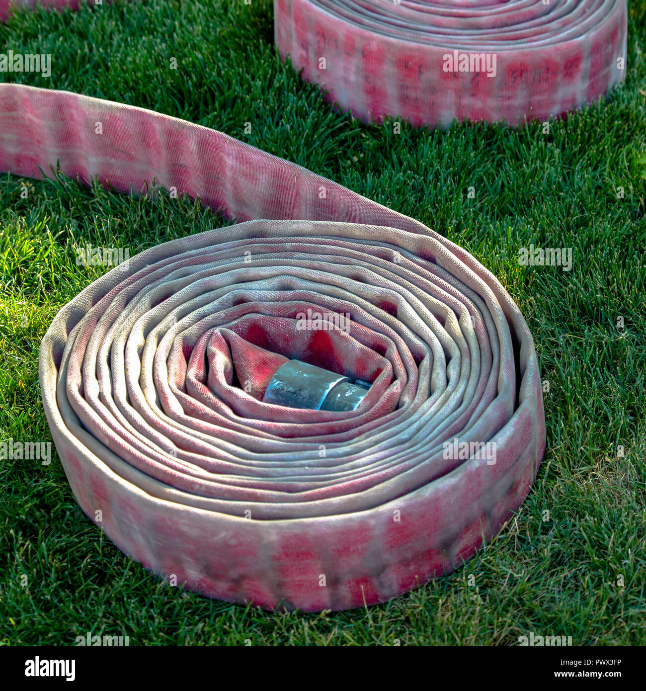 Fire hose coiled hi-res stock photography and images - Alamy