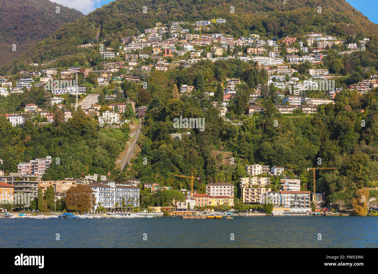 Lake Lugano and buildings on the foot of the Monte Bre mountain in ...