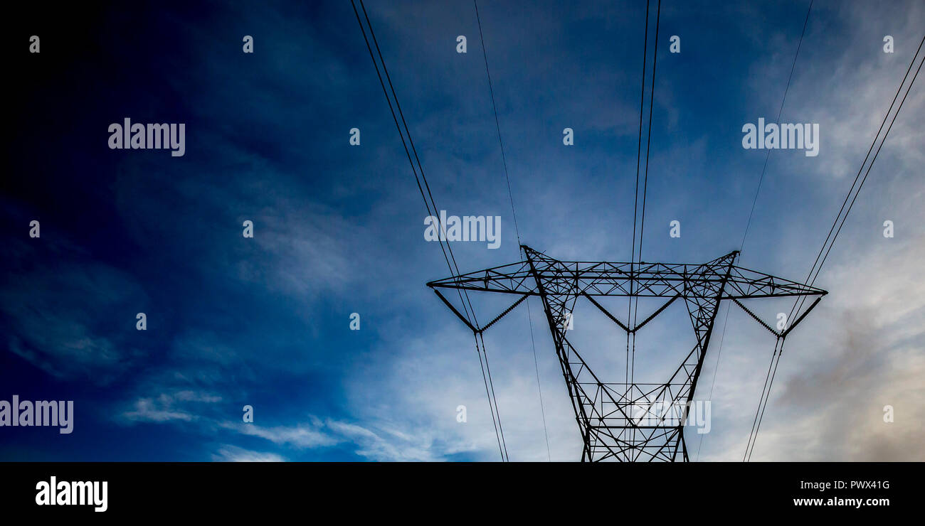 Power line against a dramatic cloudy sky Stock Photo - Alamy