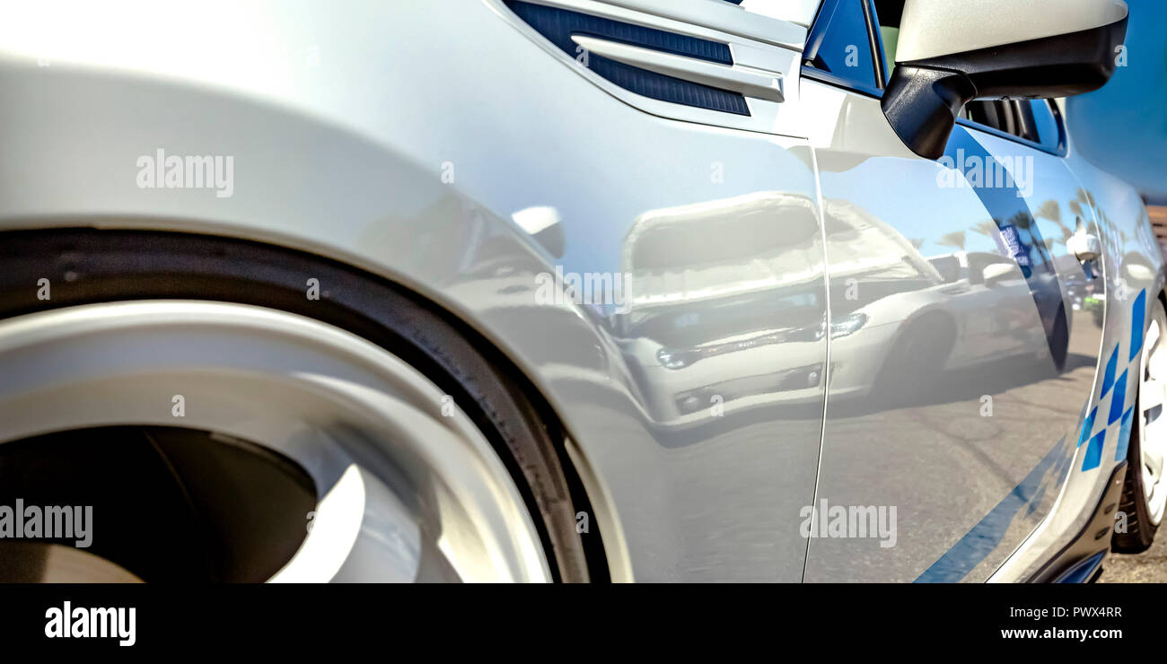 Reflective car with white rim and blue side decal Stock Photo - Alamy