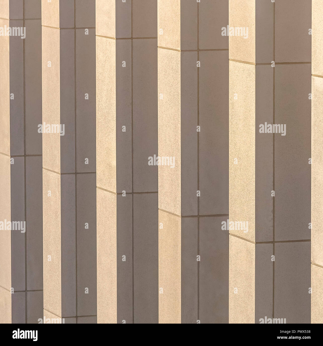 Row of sunlit concrete white rectangular columns Stock Photo - Alamy