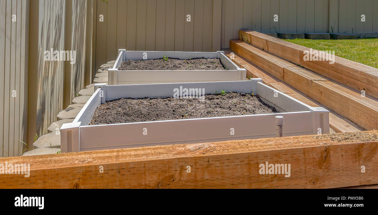 Seed box filled with soil inside a sunny backyard Stock Photo - Alamy