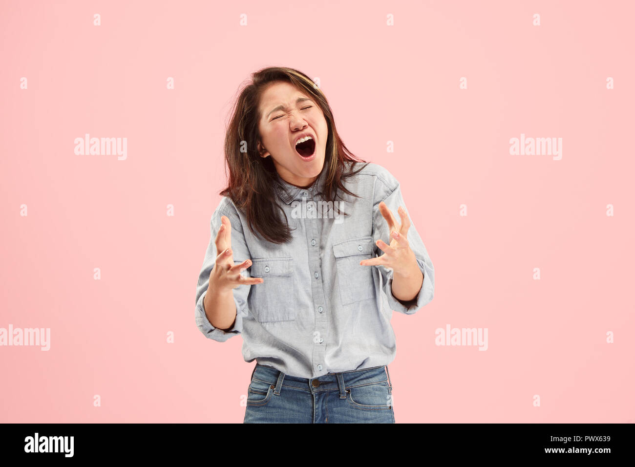 Screaming, hate, rage. Crying emotional angry woman screaming on studio ...