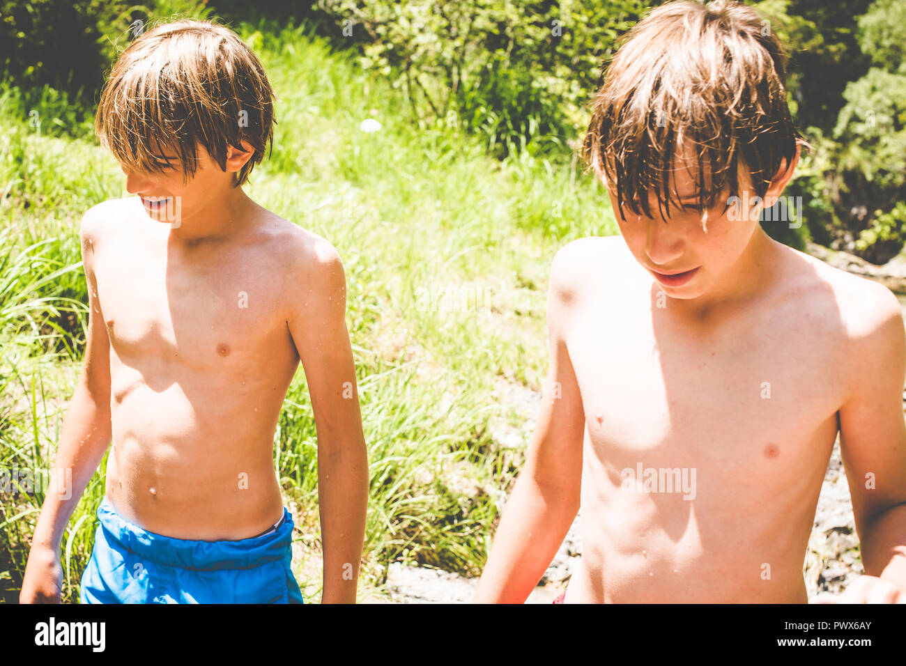 young boys have fun at the small river - outdoor summer activities ...