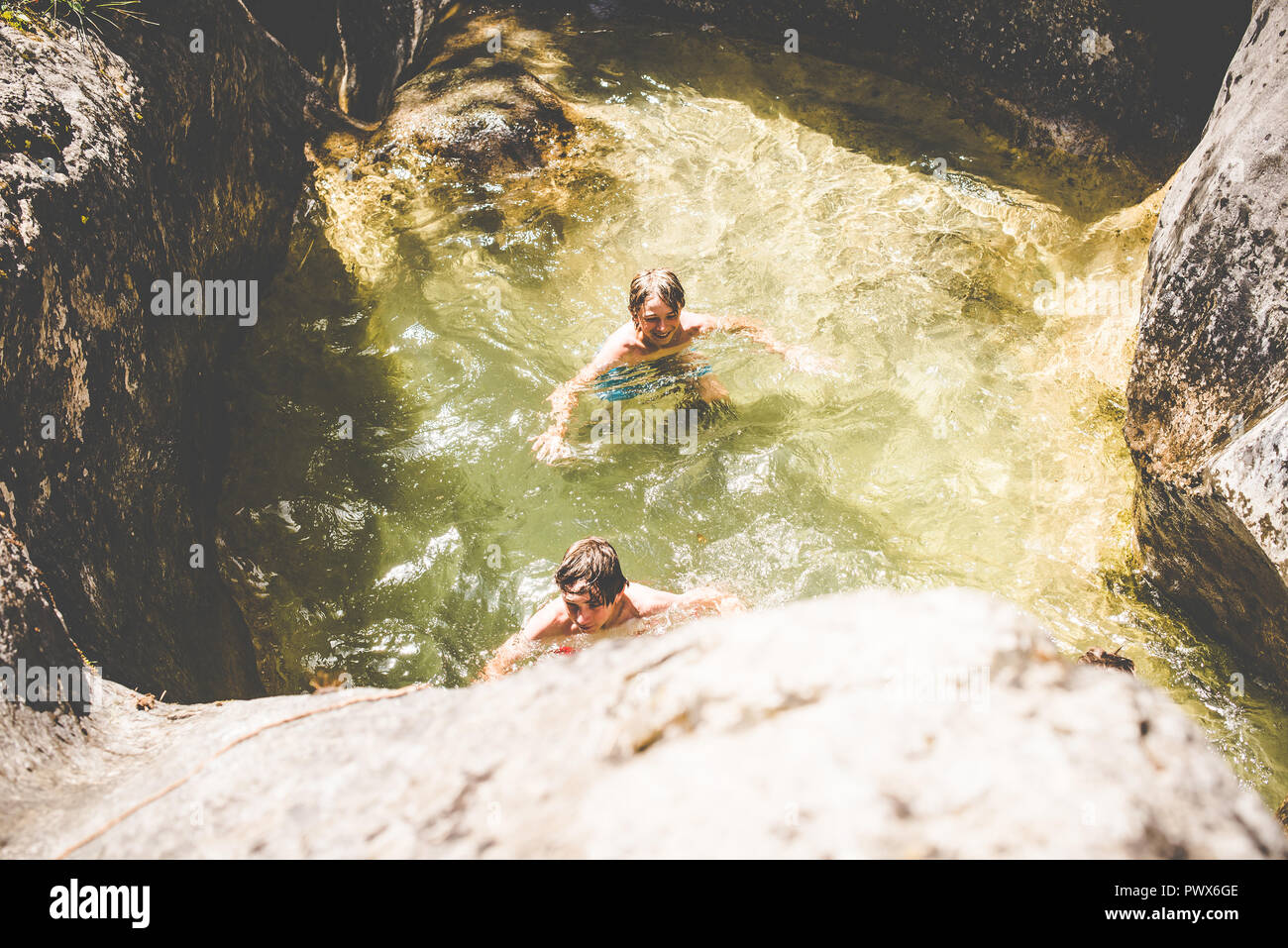 young boys have fun at the small river - outdoor summer activities ...