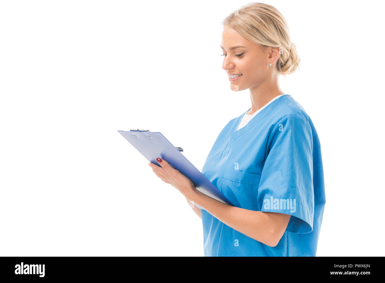confident young nurse writing in clipboard isolated on white Stock ...