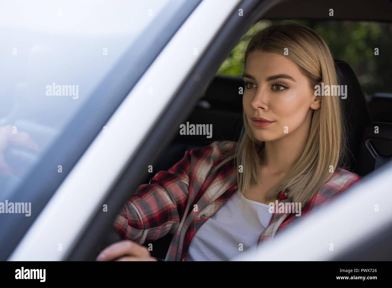 beautiful blonde girl driving white car Stock Photo - Alamy