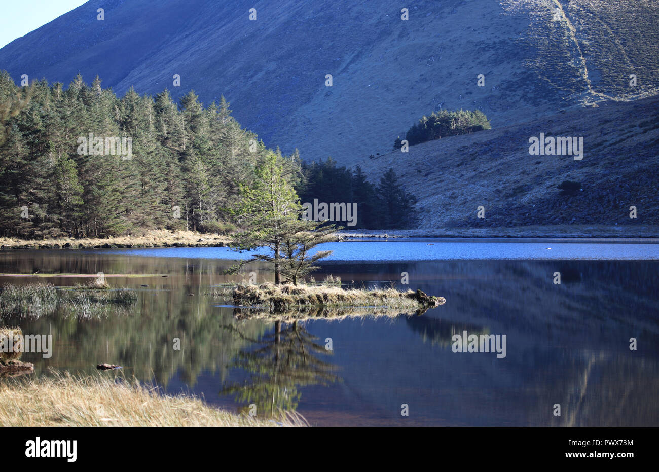 calm waters on a mountain lake, wild atlantic way, county kerry ...