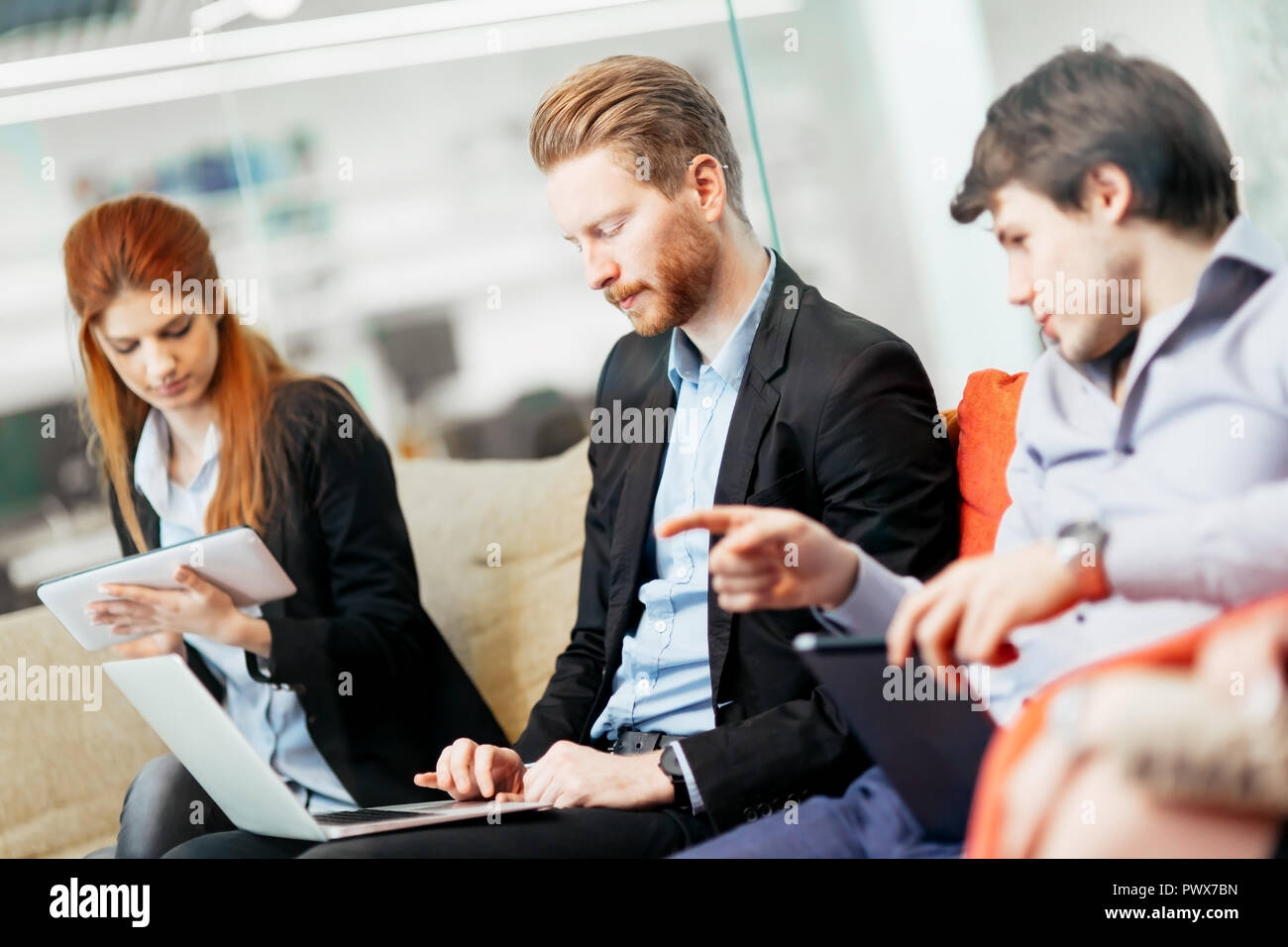 Business people collaborating in office and working on project together ...