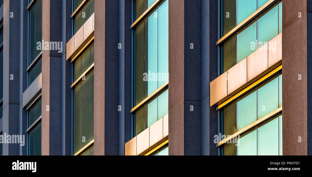 Sunlit modern building with shiny glass windows Stock Photo - Alamy