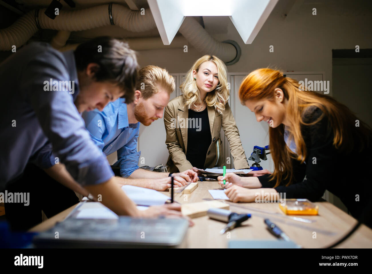 Classmates working on a project together Stock Photo - Alamy