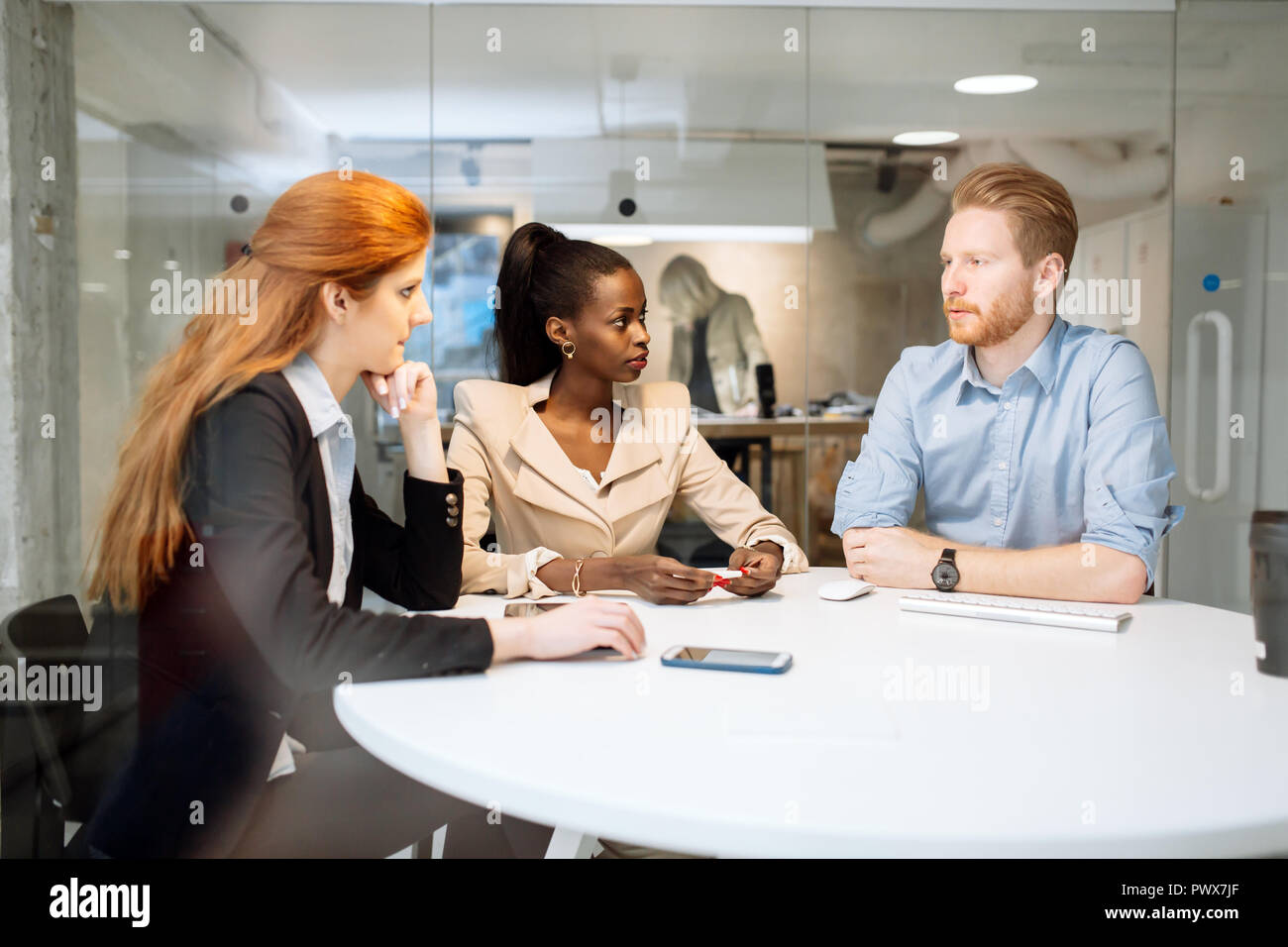 Group of business people sitting at desk Stock Photo - Alamy